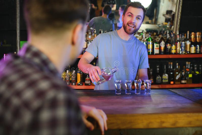 Handsome Bar Tender Standing Behind His Counter in a Pub Stock Photo ...