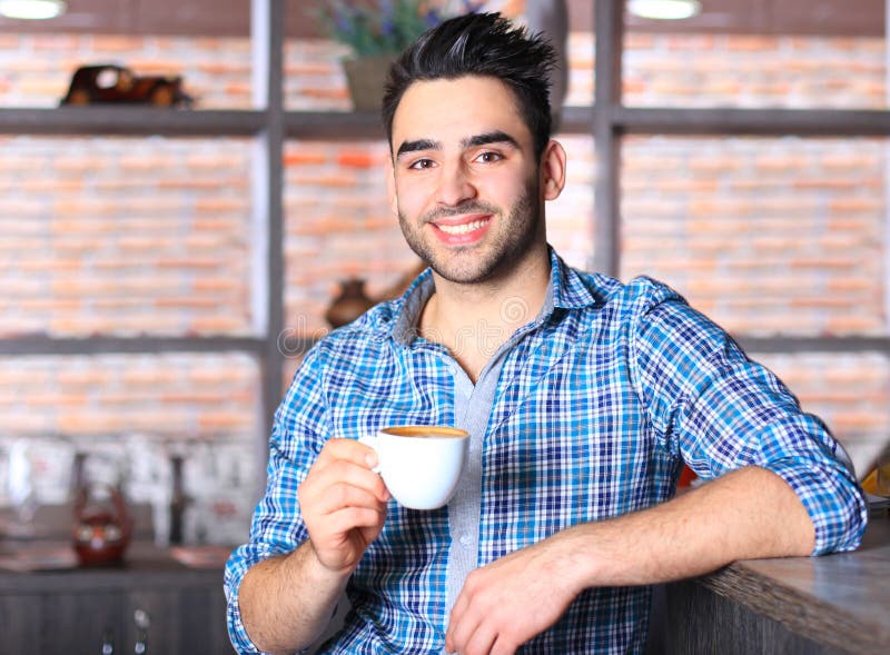 Handsome Barista Offering a Cup of Coffee To Camera at the Coffee Shop ... Handsome Barista Offering a Cup of Coffee To Camera at the Coffee Shop ...