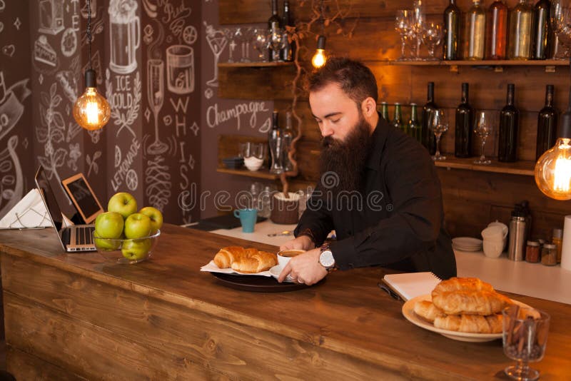 Handsome Barman Behind a Bar with a Prepared Coffee. Stock Image ...