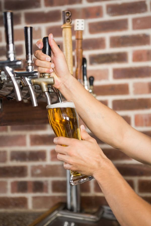 Handsome Barman Pouring a Pint of Beer Stock Photo - Image of adult ...