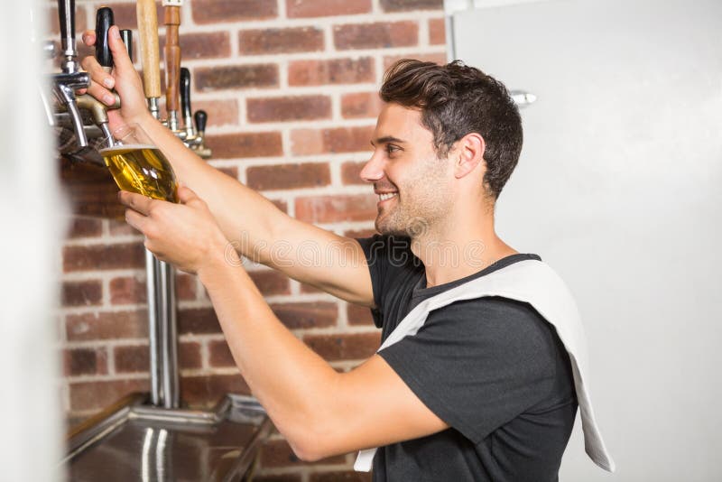Handsome Barman Pouring a Pint of Beer Stock Photo - Image of hour ...