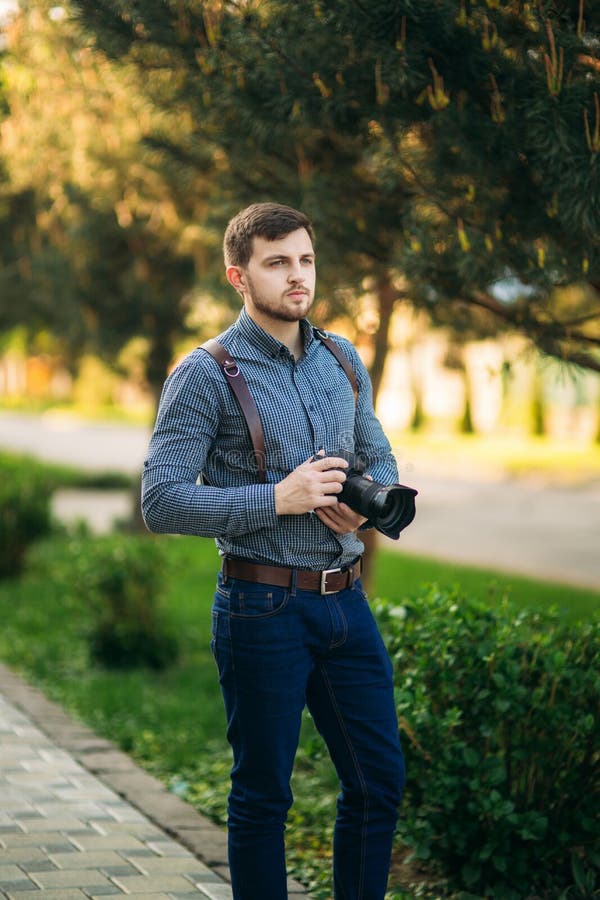 Handsome Beard Man Hold a Professional Camera in Hands. Photographer in ...