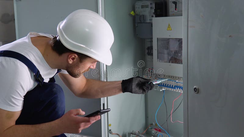 Handsome Bearded Electrician Repairing Electrical Box. Electrician ...