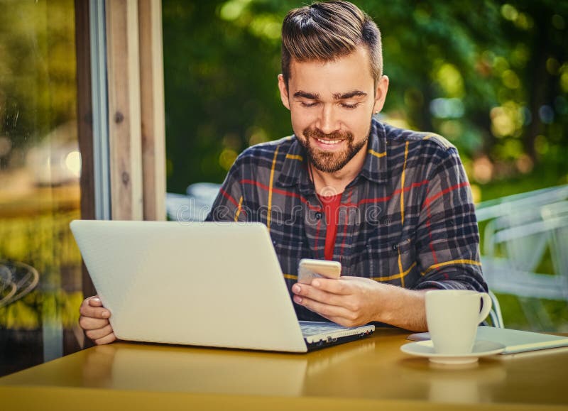A Man Using a Laptop in a Cafe. Stock Photo - Image of computer ...