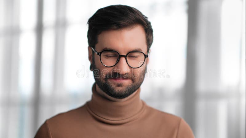 Handsome Bearded Man With Eyeglasses Looking At Camera And Smiling