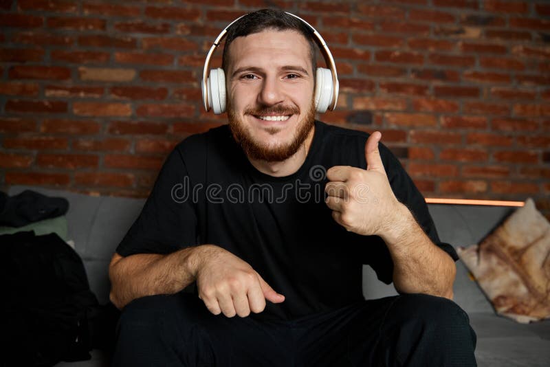 Handsome Bearded Man In Headphones Listening To Music At Home Music