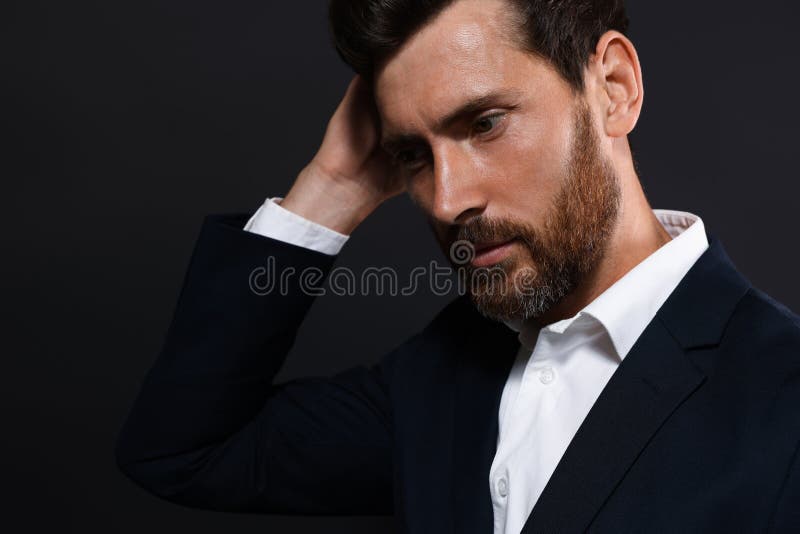 Handsome Bearded Man Looking Down on Black Background Stock Image ...