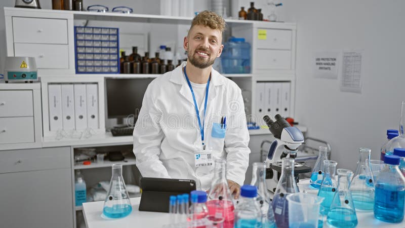 Handsome Bearded Scientist with Blue Eyes in Lab Coat Researching in a ...