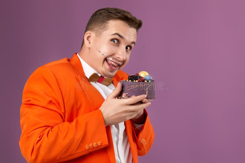 Handsome Birthday Man in Orange Jacket Eating Cake Stock Photo - Image ...