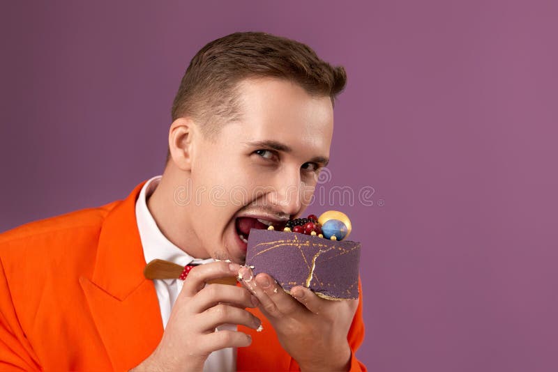 Handsome Birthday Man in Orange Jacket Eating Cake Stock Photo - Image ...