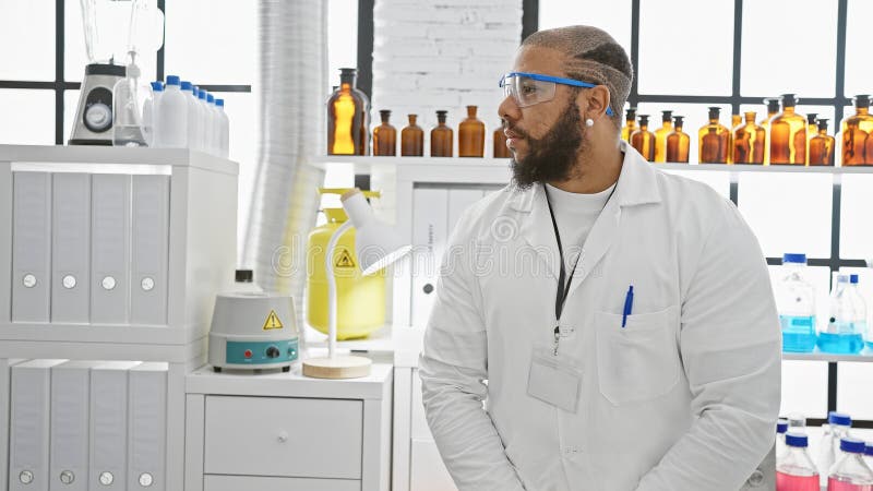 Handsome Black Man in Lab Coat Standing Thoughtfully in an Indoor ...