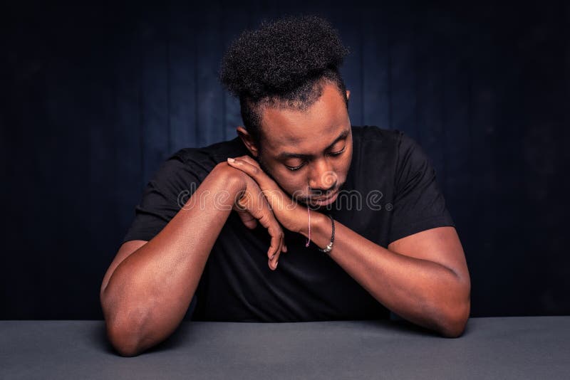 Handsome Black Man Looking Down Stock Photo - Image of seated ...