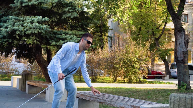 Handsome Blind Man with a Cane Approaches the Bench and Sits Down Stock ...