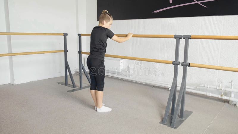 Handsome Blond Guy Performs Ballet Exercises, Kick Back. Dance School ...