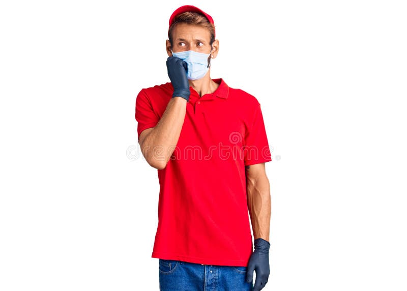 Handsome Blond Man With Beard Wearing Delivery Uniform And Medical Mask