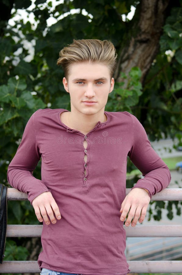 Handsome Blond Young Man on Metal Railing Outside Stock Photo - Image ... Handsome Blond Young Man on Metal Railing Outside Stock Photo - Image ...