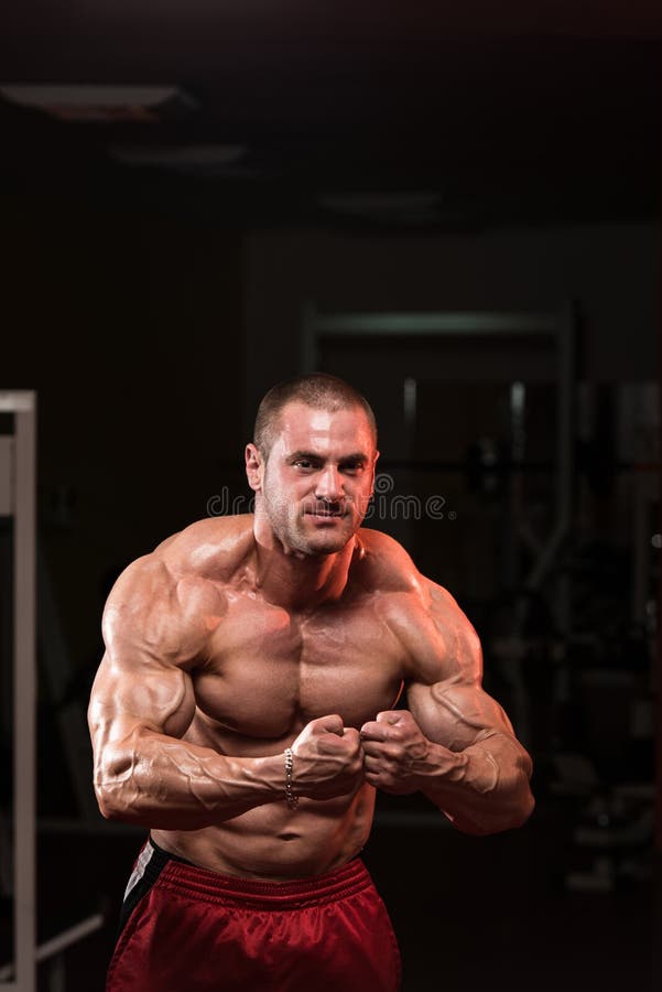 Handsome Body Builder Making Most Muscular Pose Stock Photo - Image of ...