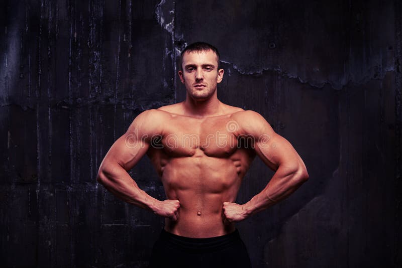Bodybuilder with Toned Trained Body Against Rough Grey Wall Stock Photo ...