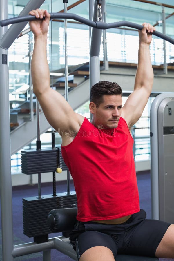 Handsome Bodybuilder Using Weight Machine Arms Stock Photos - Free ...