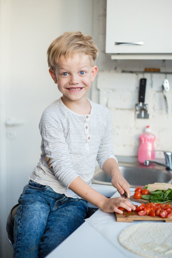Handsome Boy is Cooking in the Kitchen at Home. Healthy Food Stock ...