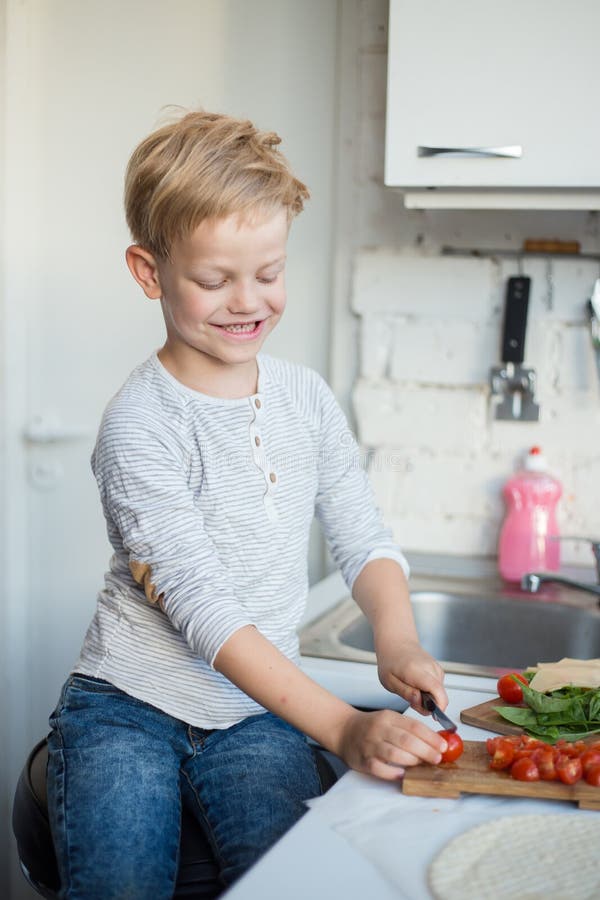 Handsome Boy is Cooking in the Kitchen at Home. Healthy Food Stock ...