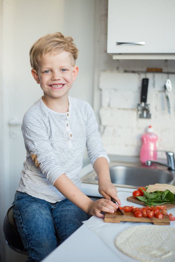 Handsome Boy is Cooking in the Kitchen at Home. Healthy Food Stock ...