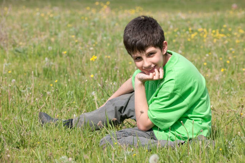 Handsome boy on the meadow stock photo. Image of green - 14161610