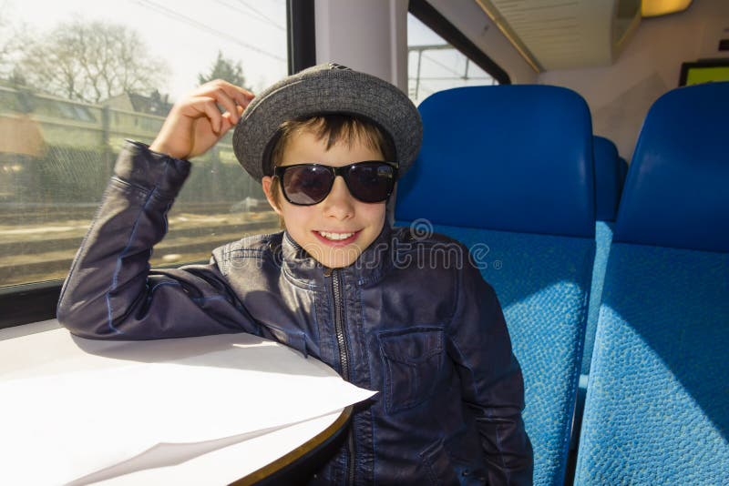 Handsome Boy with Sunglasses Rides on a Train Reading from the Paper ...