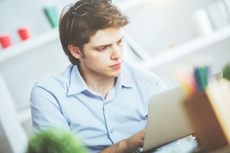 Handsome boy using laptop stock image. Image of adult - 80990149