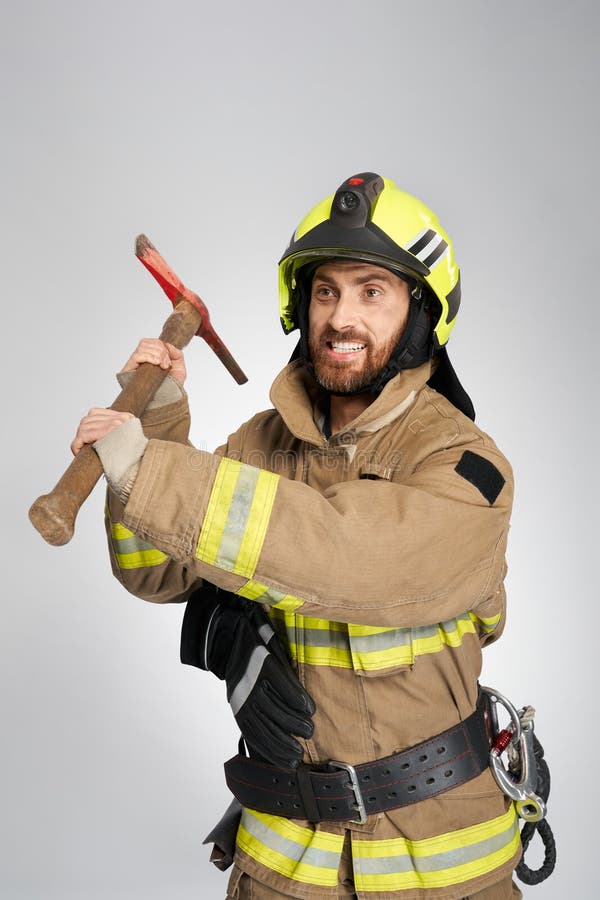 Handsome Brave Firefighter Battling Fire, while Using Shabby Ax. Stock ...