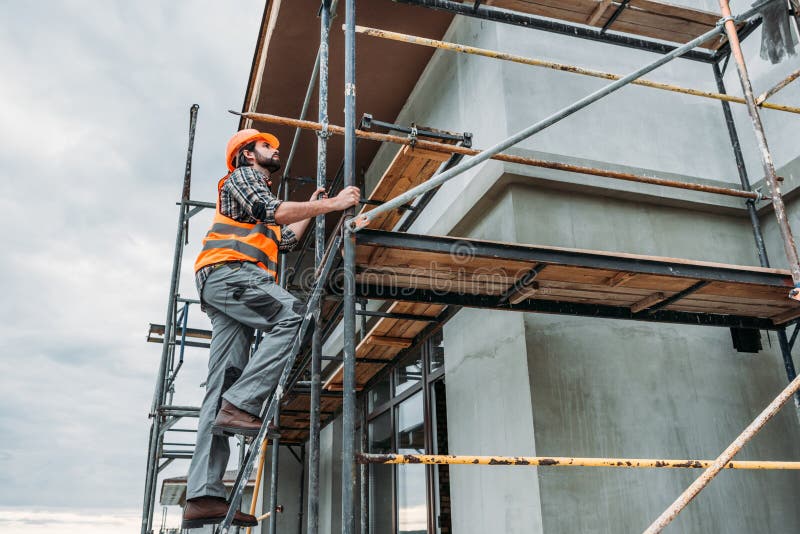 Handsome Builder Climbing on Scaffolding Stock Photo - Image of person ...