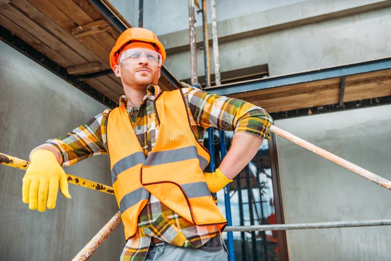 Handsome Builder Leaning on Scaffolding at Construction Site Stock ...