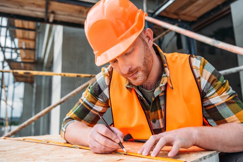 Handsome Builder Using Measuring Tape and Pencil Stock Image - Image of ...