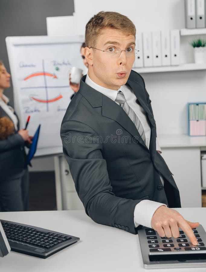 Handsome Businessman Calculating at Calculator Stock Image - Image of ...