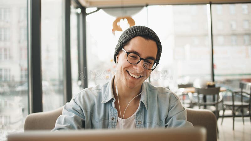 Handsome Businessman In Casual Wear And Eyeglasses Is Using A Laptop In
