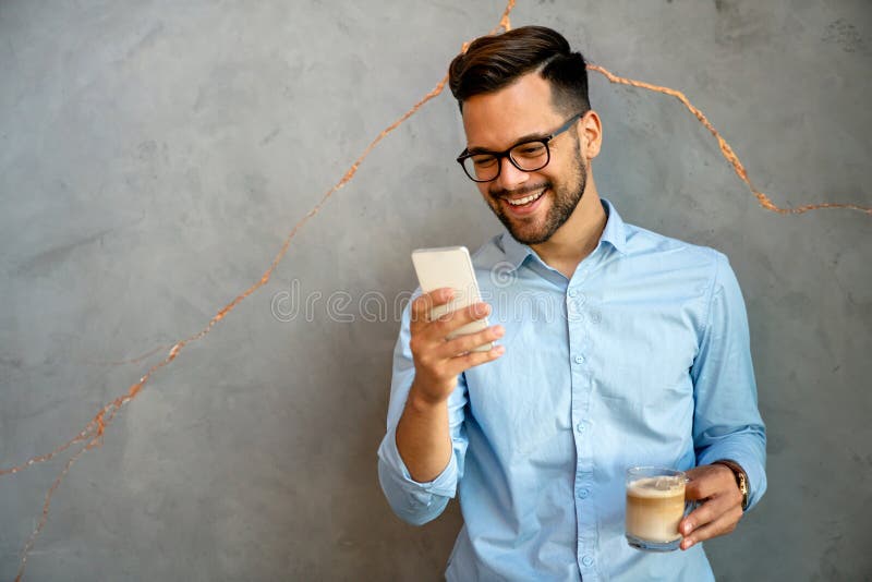 Handsome Businessman Checking Emails on the Phone in Modern Office in ...