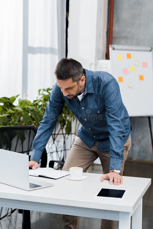 Handsome Businessman Leaning on Table and Looking at Table Stock Image ...