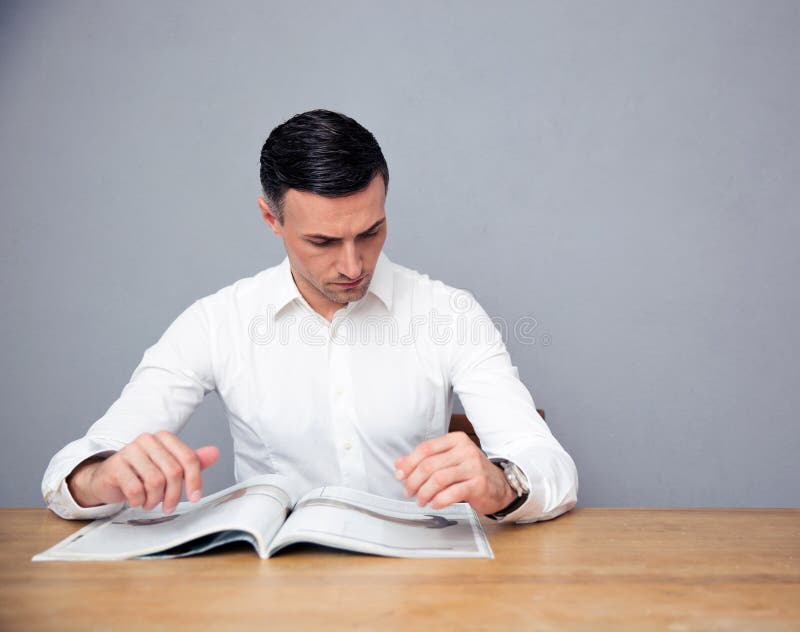 Handsome Businessman Reading Magazine Stock Photo - Image of grey ...