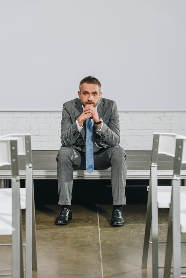 Handsome Businessman Sitting on Stage in Hub and Looking Stock Photo ...