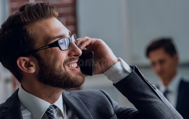 Handsome Businessman Speaking on Mobile Phone in Office Stock Photo ...