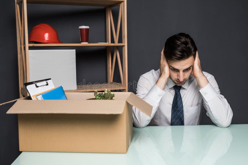 Getting Fired. Handsome Businessman in Suit is Sitting Sadly at the ...