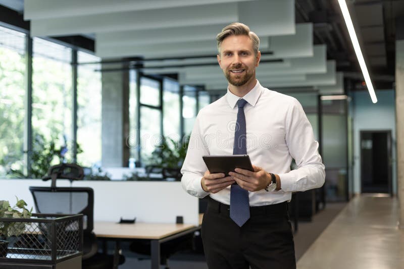 Handsome Businessman Using His Tablet in the Office Stock Image - Image ...