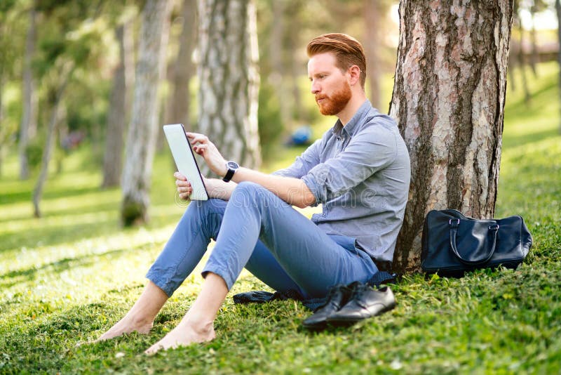 Businessman Using Tablet in Park Stock Image - Image of computer, green ...
