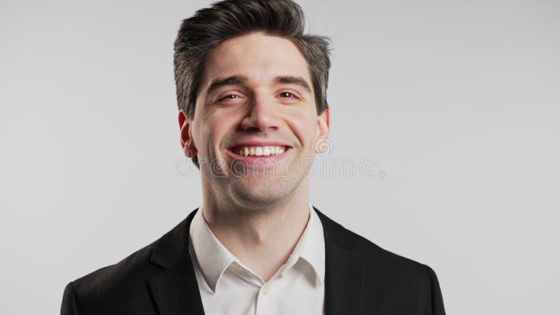 Handsome Businessman Winking Eye, Smiling To Camera. Guy in Studio on ...