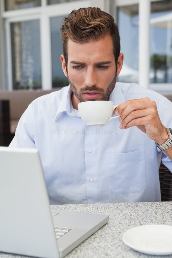 Handsome Businessman Working with Laptop Drinking Coffee Stock Photo ...