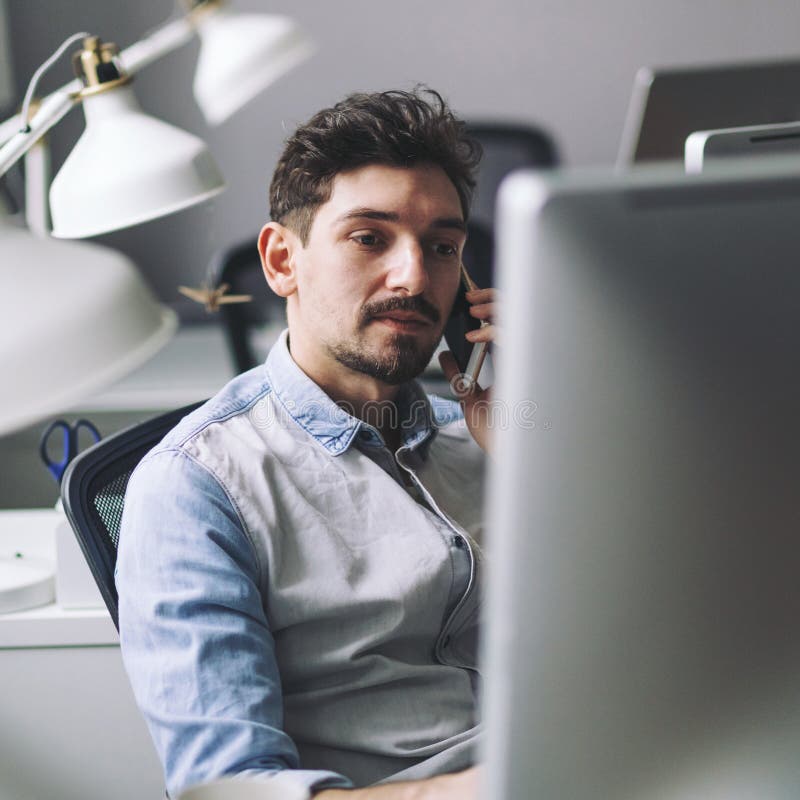 Handsome Businessman Working in Office Using Mobile Phone Stock Photo ...