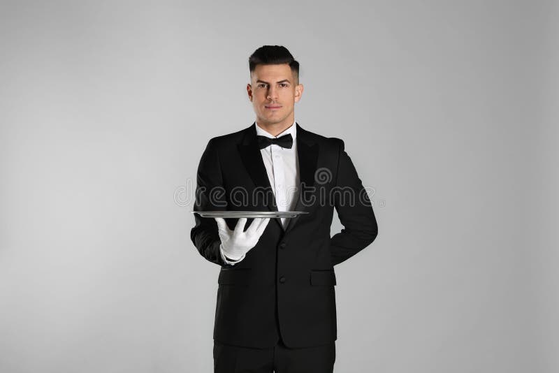 Handsome Butler in Elegant Uniform on Grey Background Stock Image ...