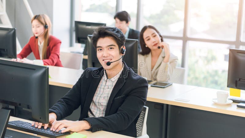 Handsome Call Center Operator Smiling at Camera while Using Headset ...