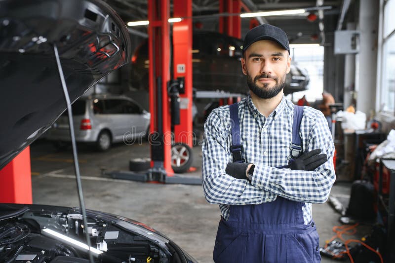 Handsome Car Mechanic is Posing in a Car Service. Stock Photo - Image ...