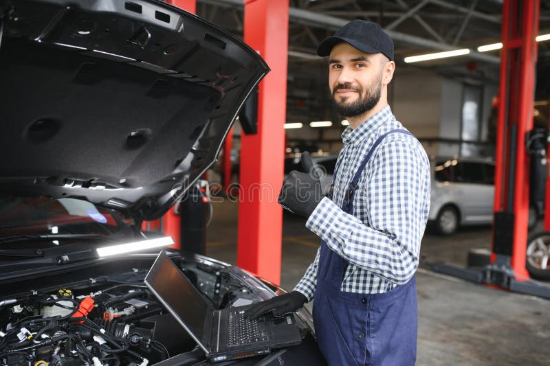 Handsome Car Mechanic is Posing in a Car Service. Stock Image - Image ...